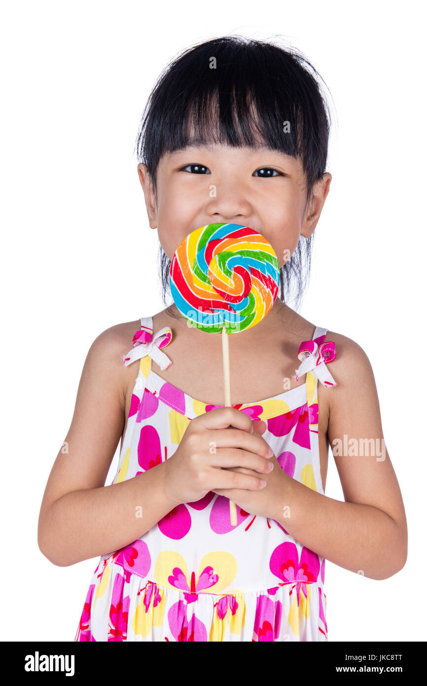 Asian Little Chinese girl eating lollipop in isolated white background ...