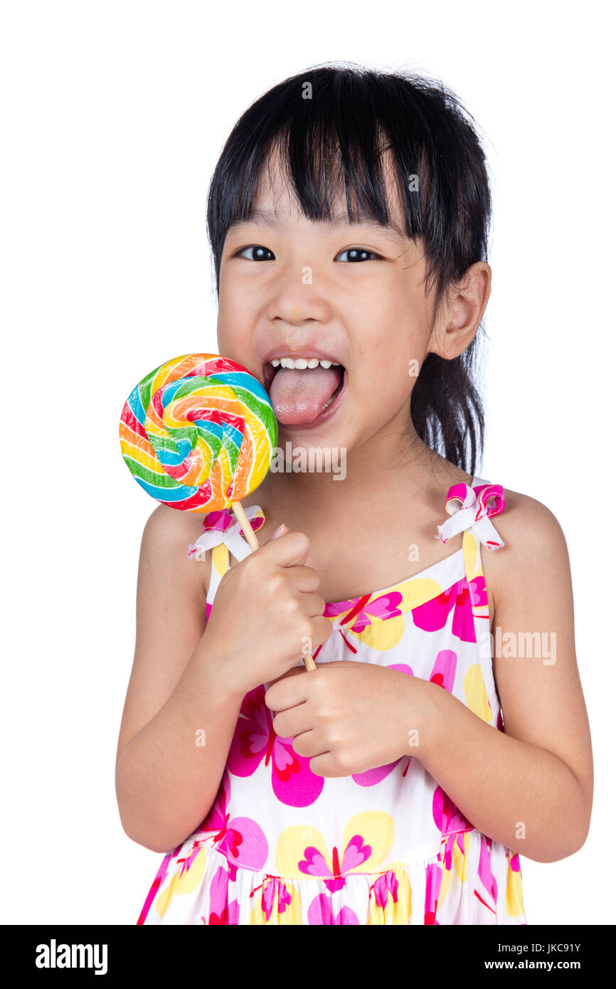 Asian Little Chinese girl eating lollipop in isolated white background ...