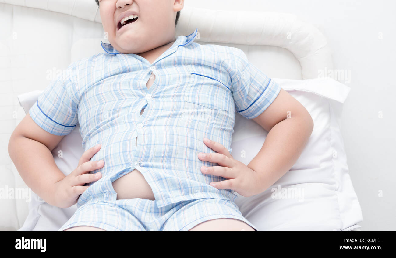 Obese fat boy overweight stomachache on bed, healthy concept Stock ...