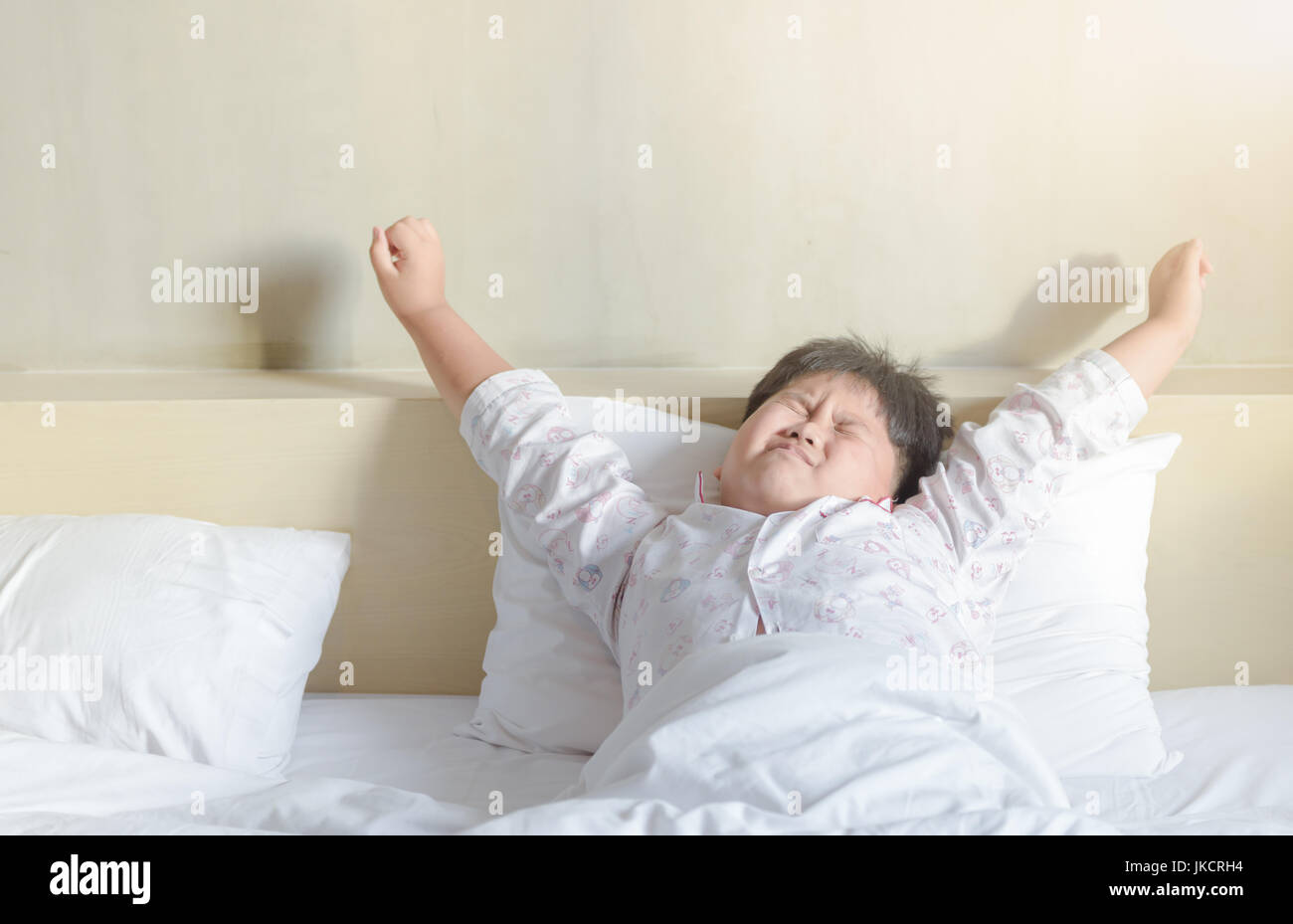obese fat boy wakes up and stretching on bed in morning Stock Photo - Alamy