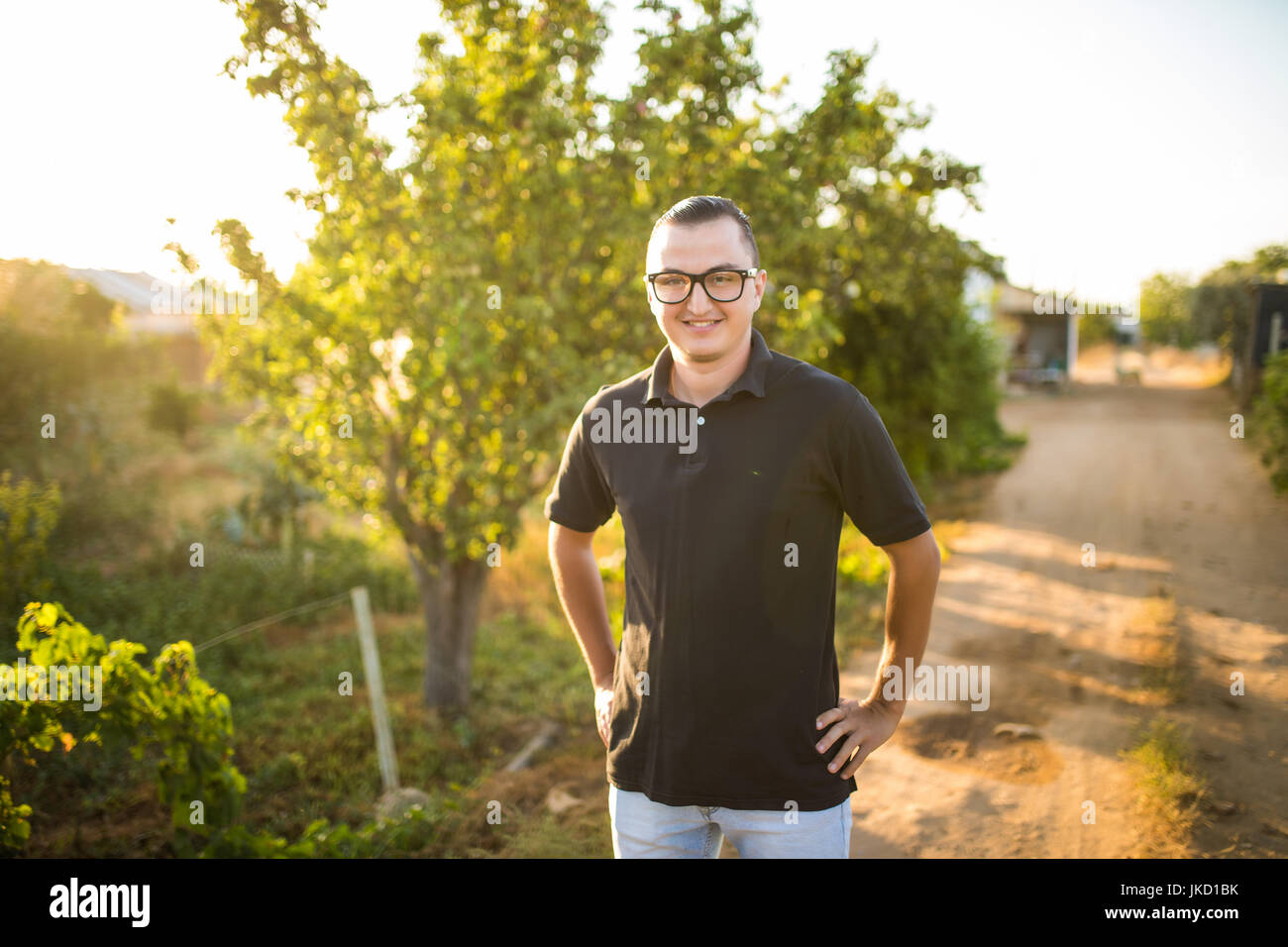 Portrait of confident male gardener standing with arms crossed at ...