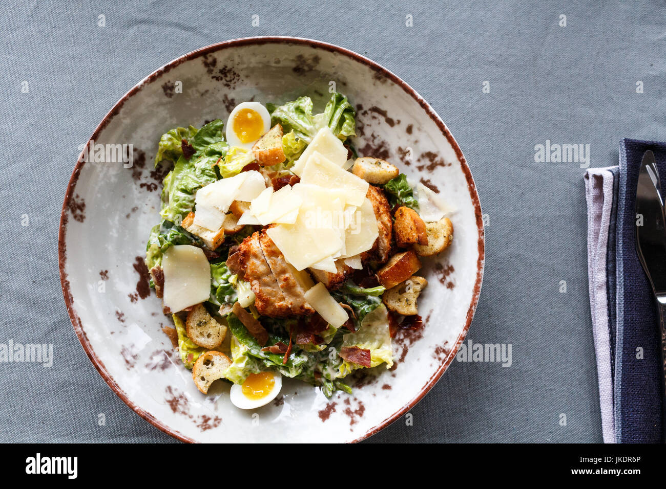 Caesar salad in a round plate Stock Photo - Alamy
