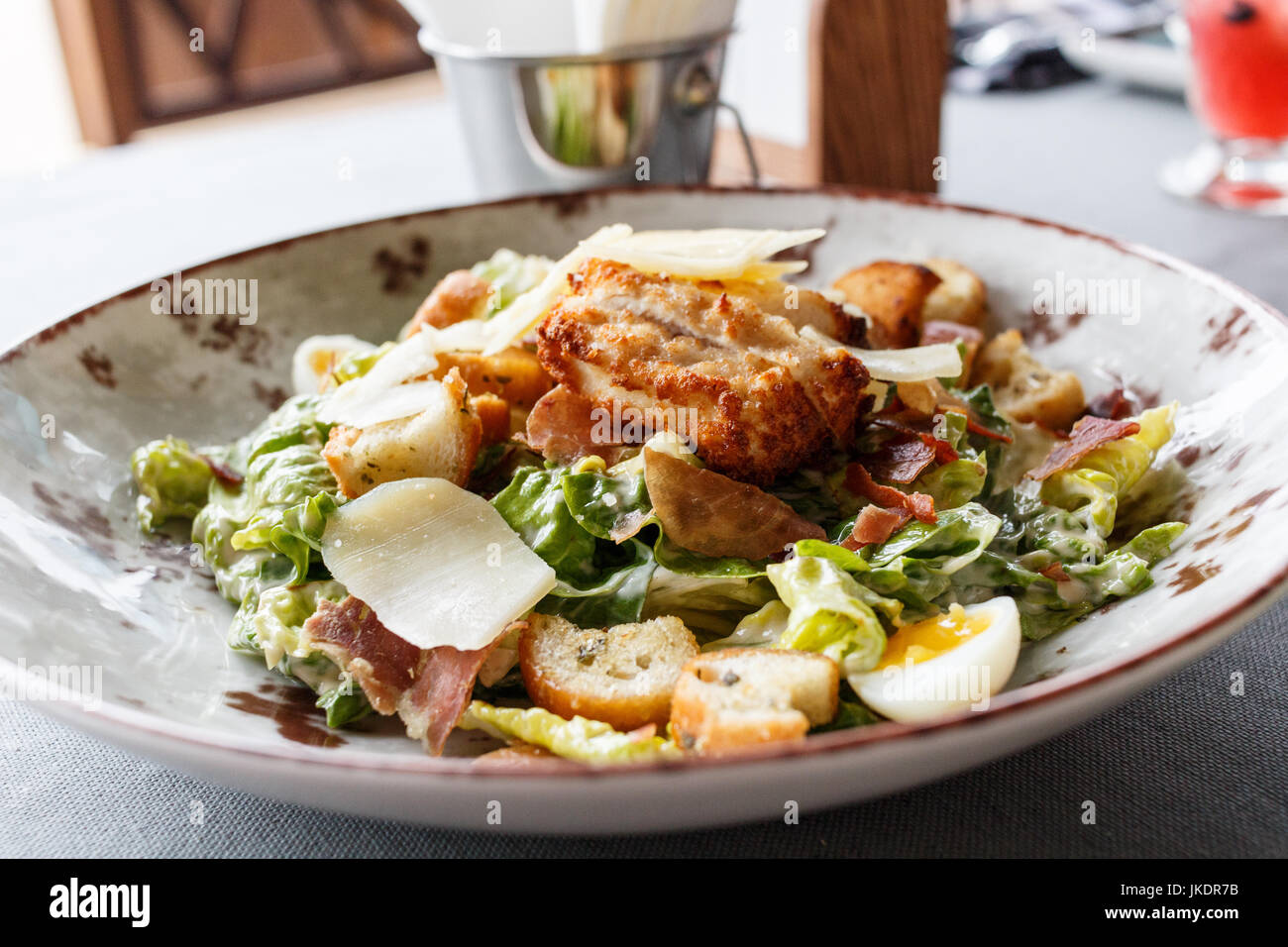 Caesar salad in a round plate Stock Photo - Alamy