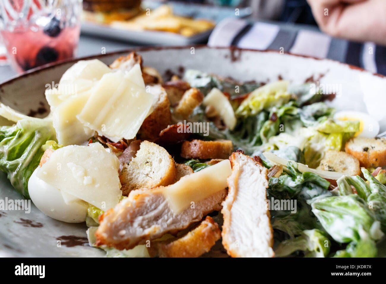 Caesar salad in a round plate Stock Photo - Alamy