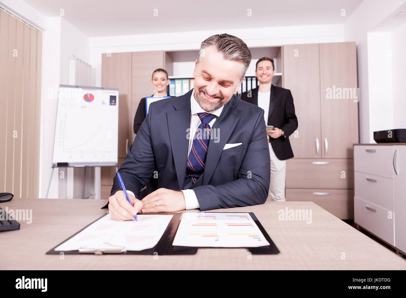 Business colleagues writing on charts hi-res stock photography and ...