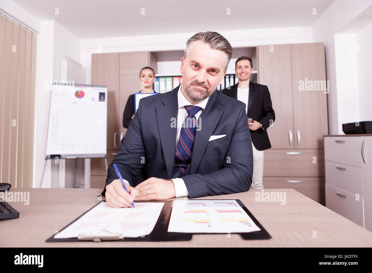 Business colleagues writing on charts hi-res stock photography and ...
