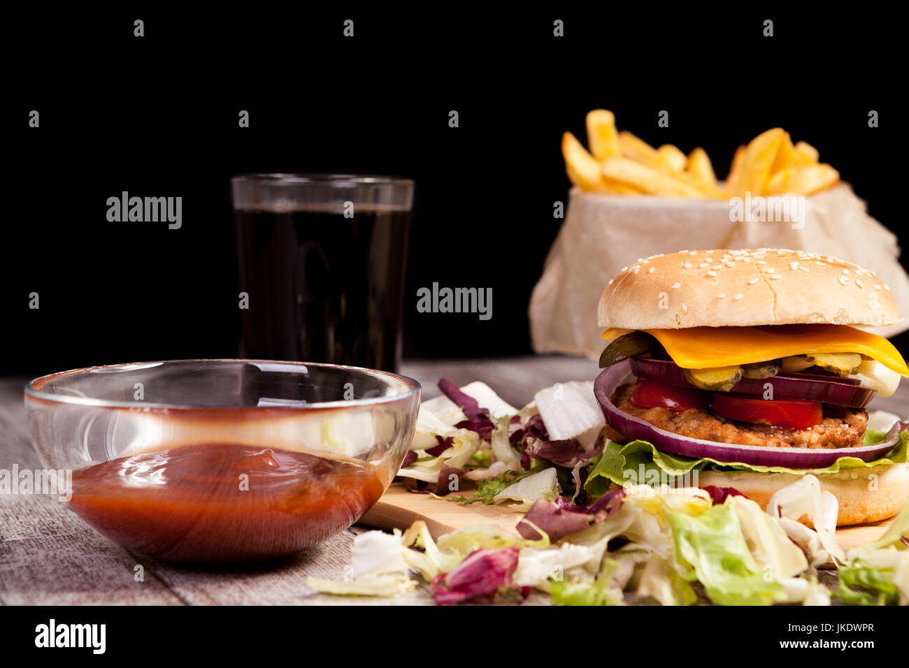 Burger on wooden plate Stock Photo - Alamy