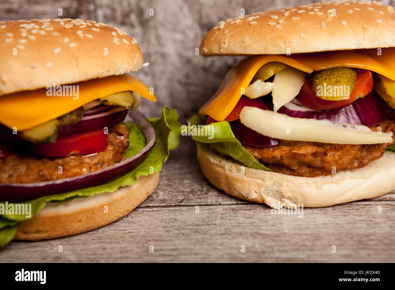 Burgers on wooden plate Stock Photo - Alamy
