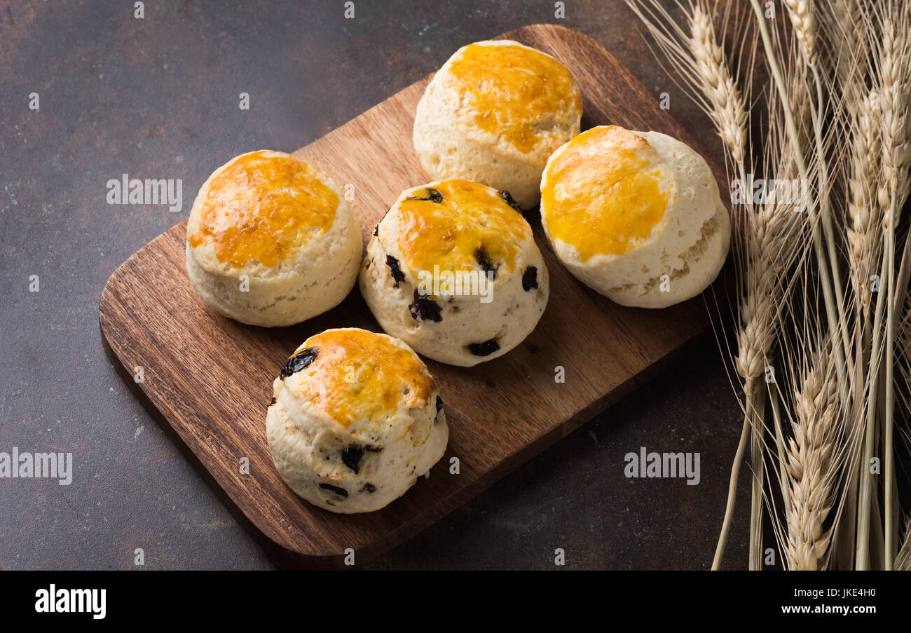 Traditional delicious British pastry and desert - scones on wood block ...