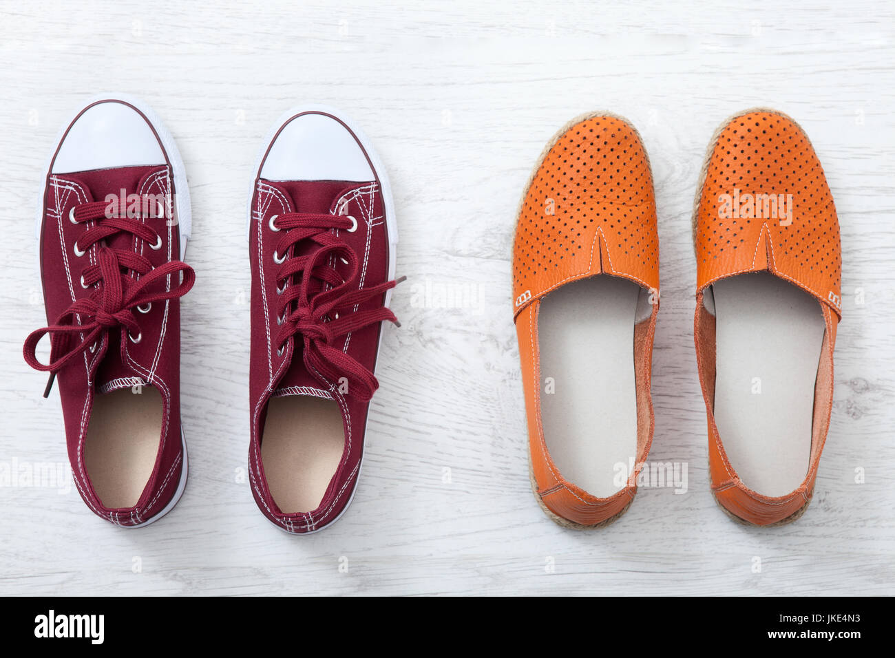 Flat lay fashion set: colored slippers shoes on white wooden background ...