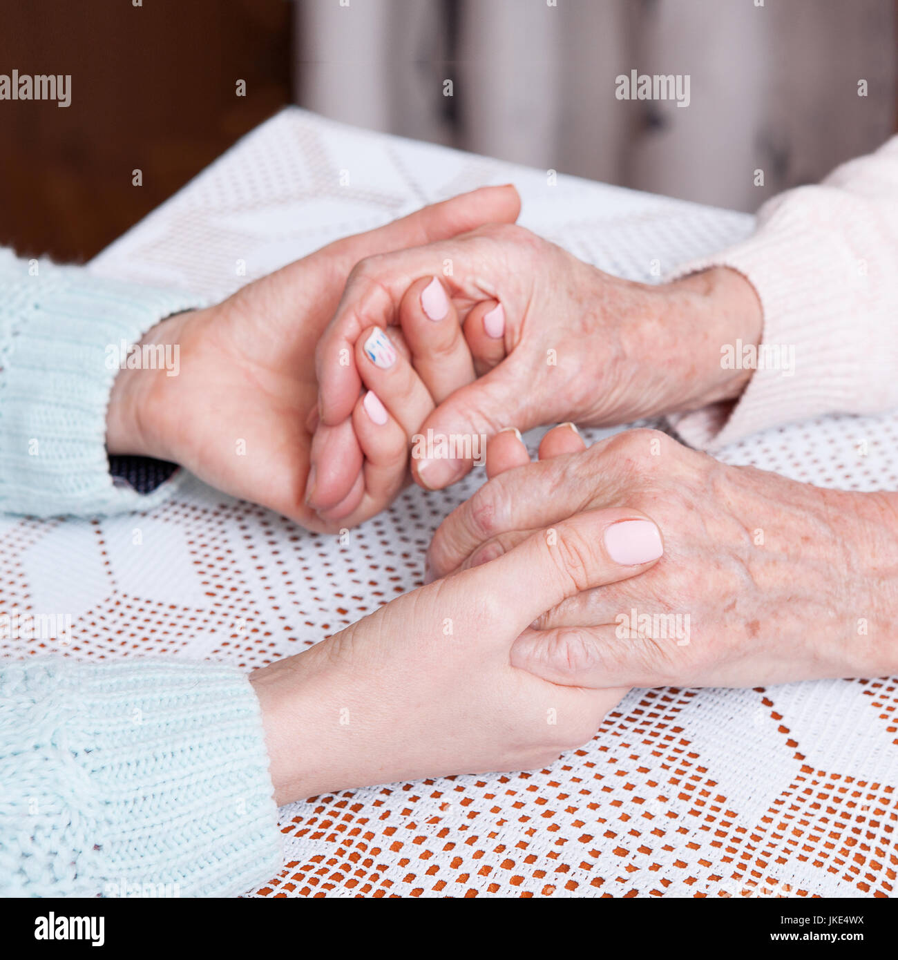 A care is at home of elderly. Holding hands closeup Stock Photo - Alamy
