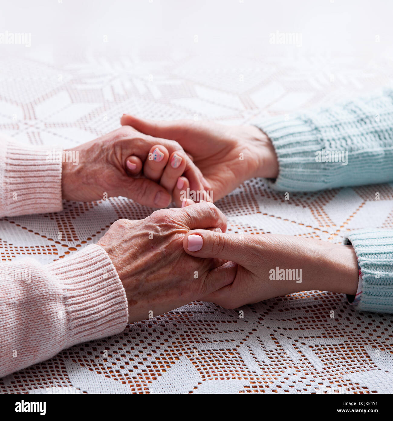 A care is at home of elderly. Holding hands closeup Stock Photo - Alamy