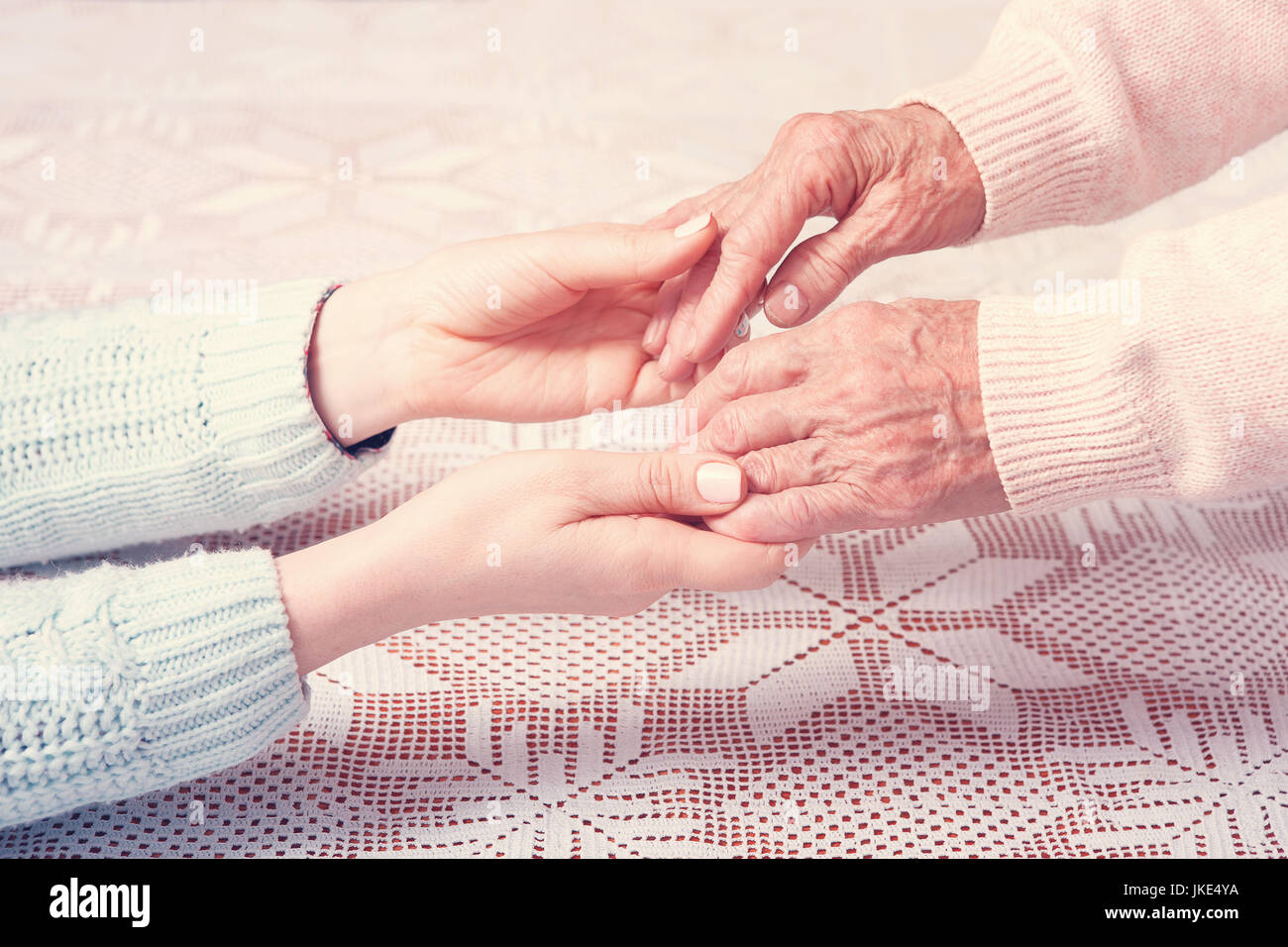 A care is at home of elderly. Holding hands closeup Stock Photo - Alamy