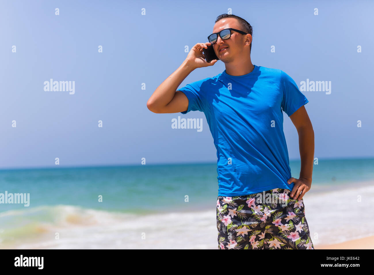 Young man talking on telephone in the beach. Summer time Stock Photo ...