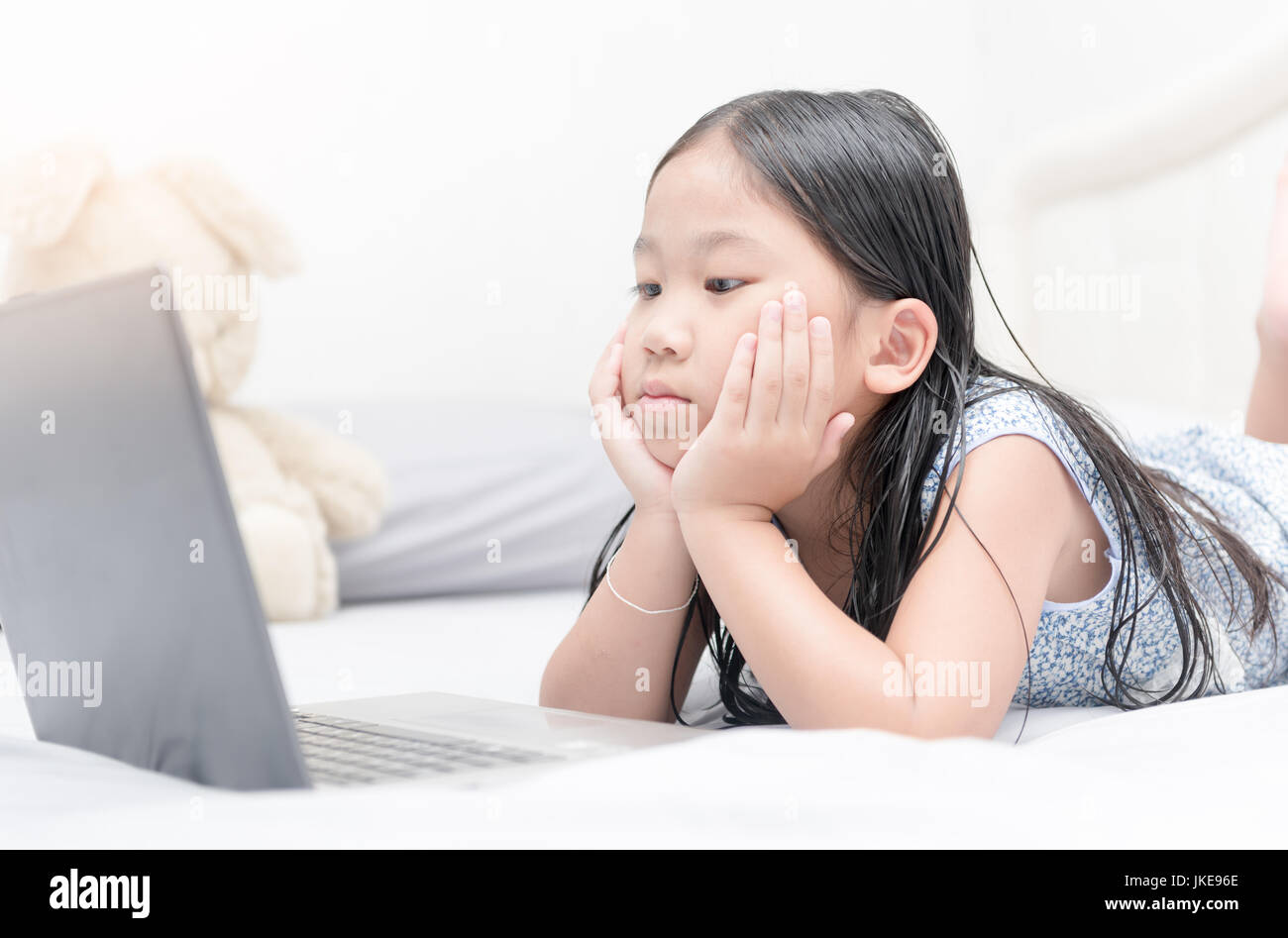 cute girl looking computer on bed, education concept Stock Photo - Alamy