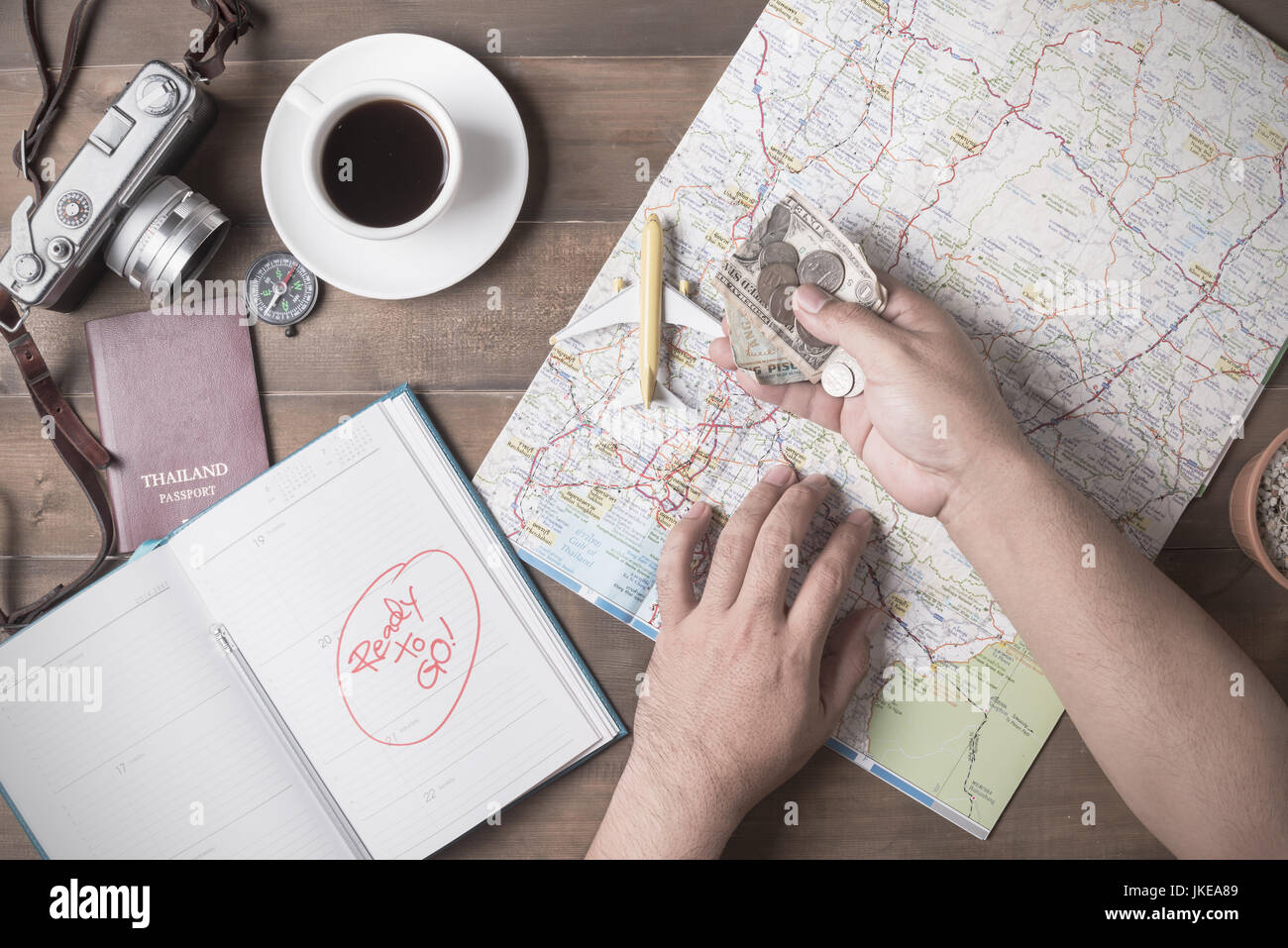 foreign money in hand man for prepare to travel on Thailand map ...