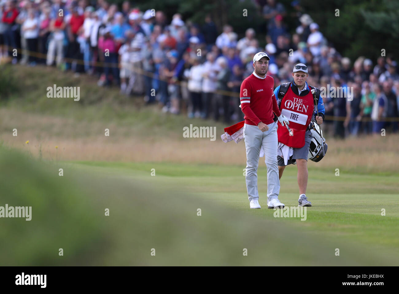 England's Toby Tree and caddie walk up the fairway during day four of ...