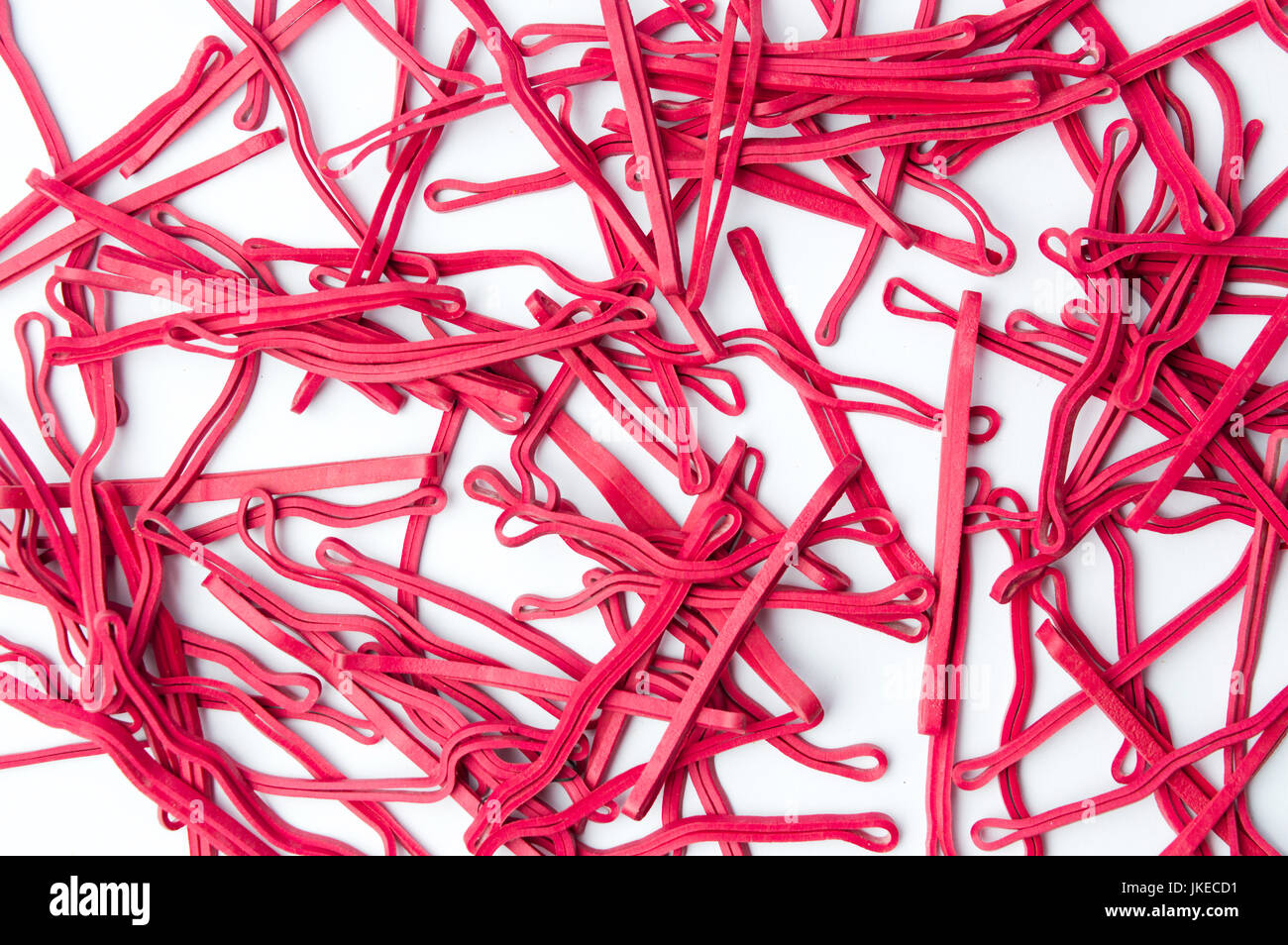 Bunch of red rubber bands isolated on white Stock Photo - Alamy