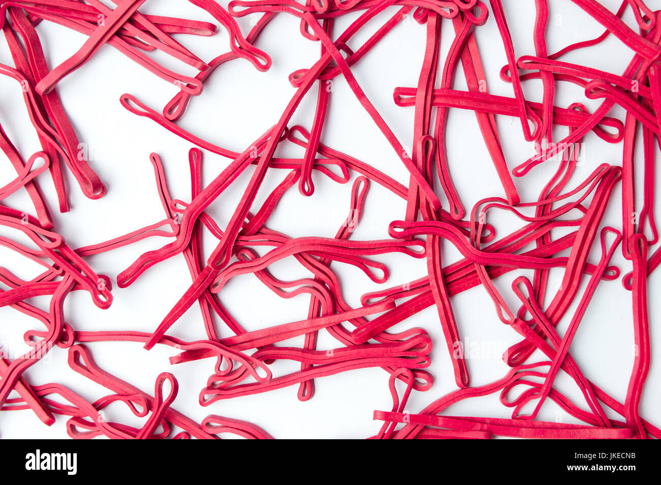 Bunch of red rubber bands isolated on white Stock Photo - Alamy