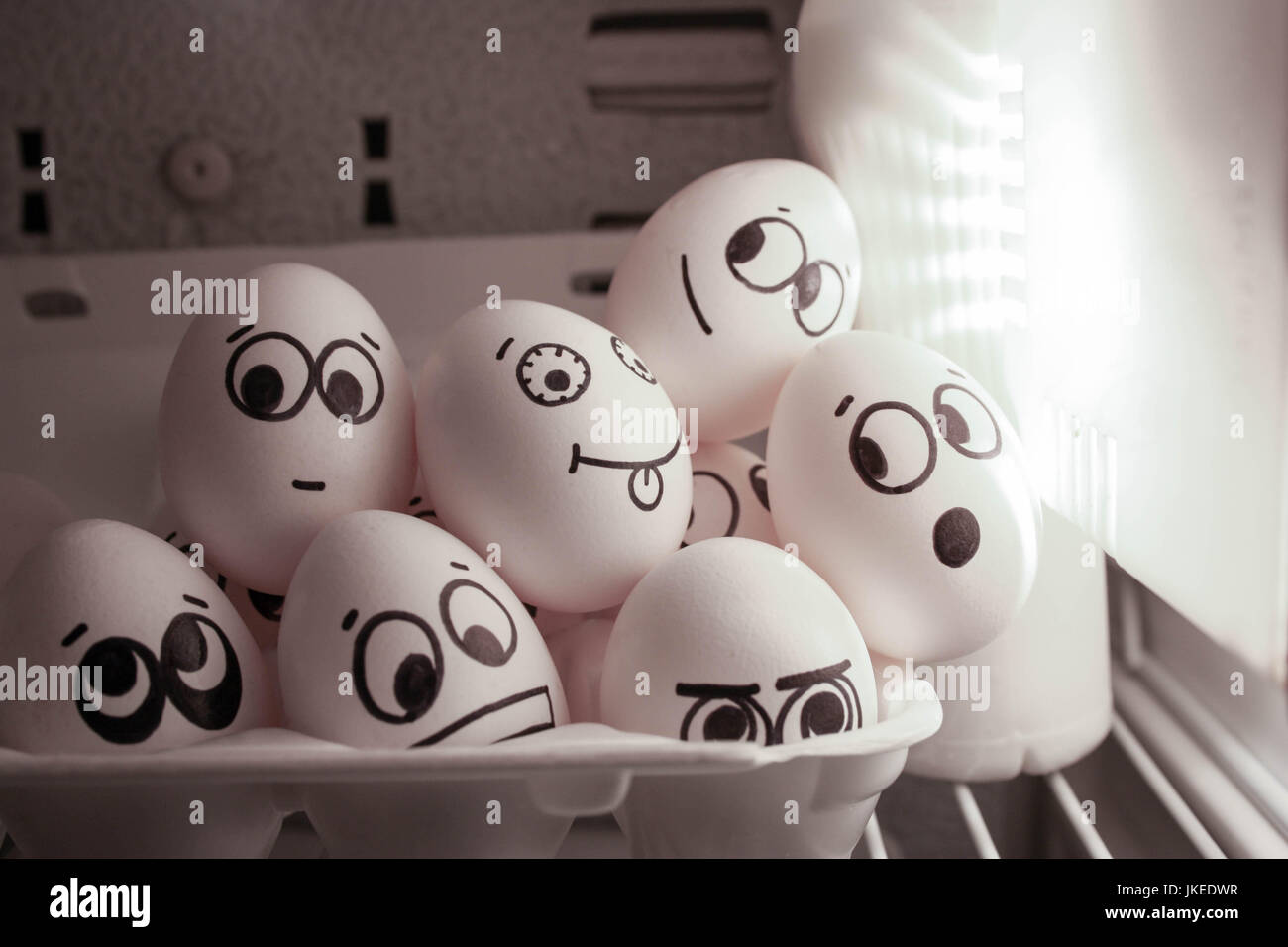 Concept of evening with friends on sofa. Face eggs are funny in the ...