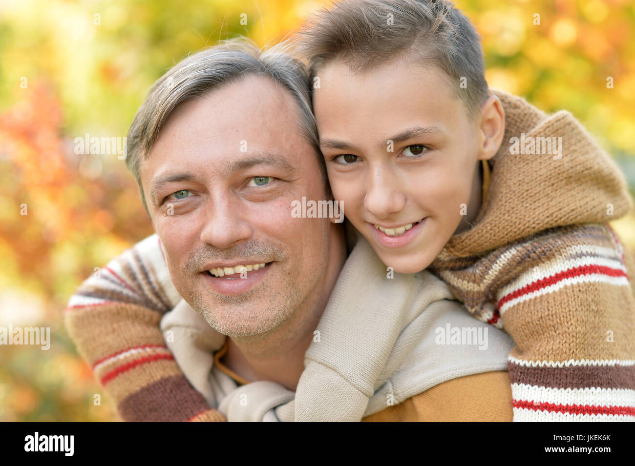 Portrait of father and son in autumn park Stock Photo - Alamy