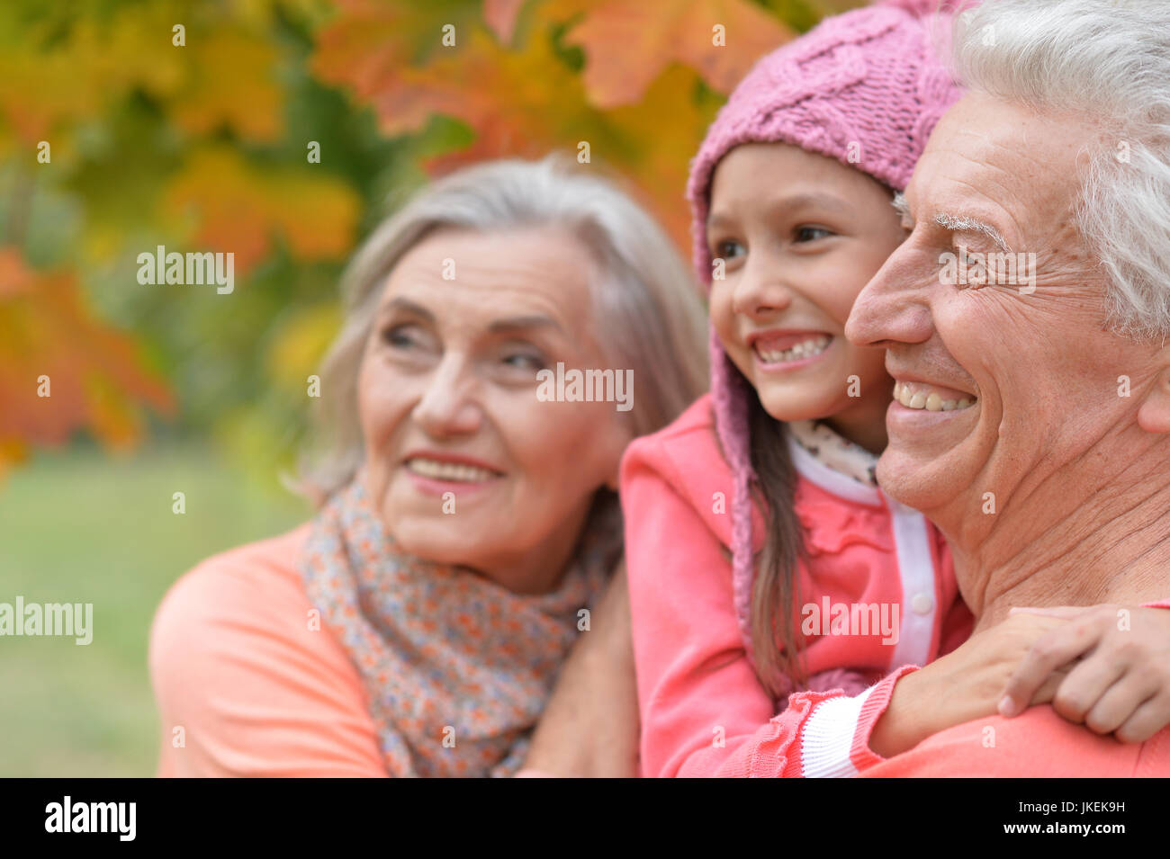 Family portrait of happy grandparents and granddaughter Stock Photo - Alamy