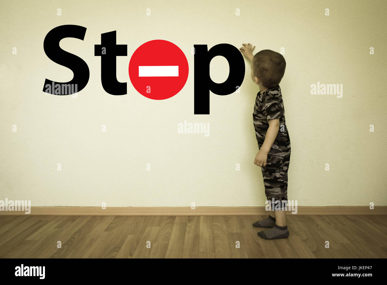 Concept of cautiously children on the road. Stop. The little boy draws ...