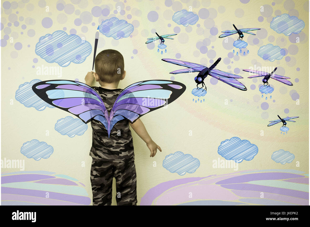 Concept of creativity child. The little boy draws on the wall. Flying ...