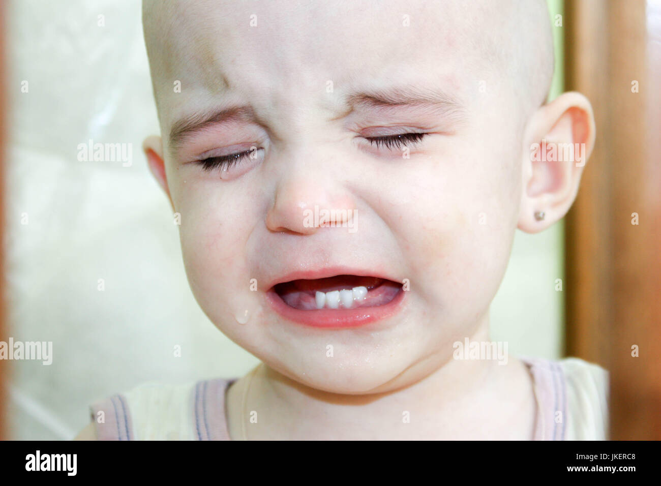 Teeth are cut in the baby. Pain and discomfort. Crying childish. Photo ...