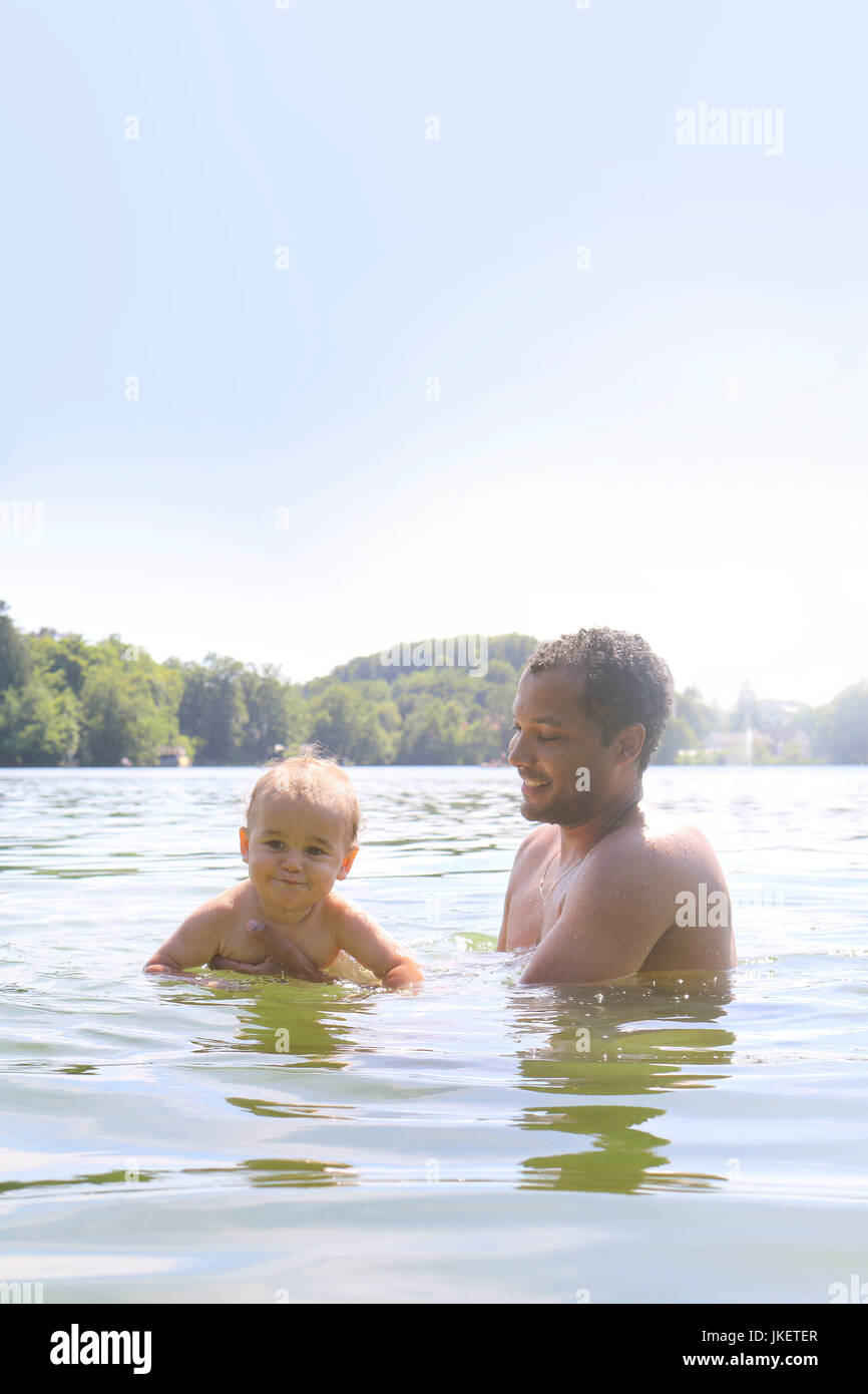 Happy Father teaching son to swim Stock Photo - Alamy