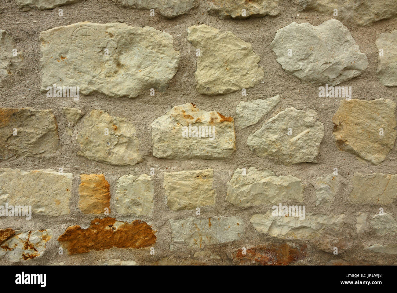Old, porous stone wall as a very interesting background and texture ...