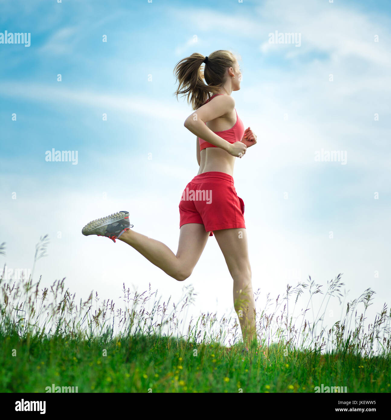 Young lady running. Woman runner running through the summer park rural ...