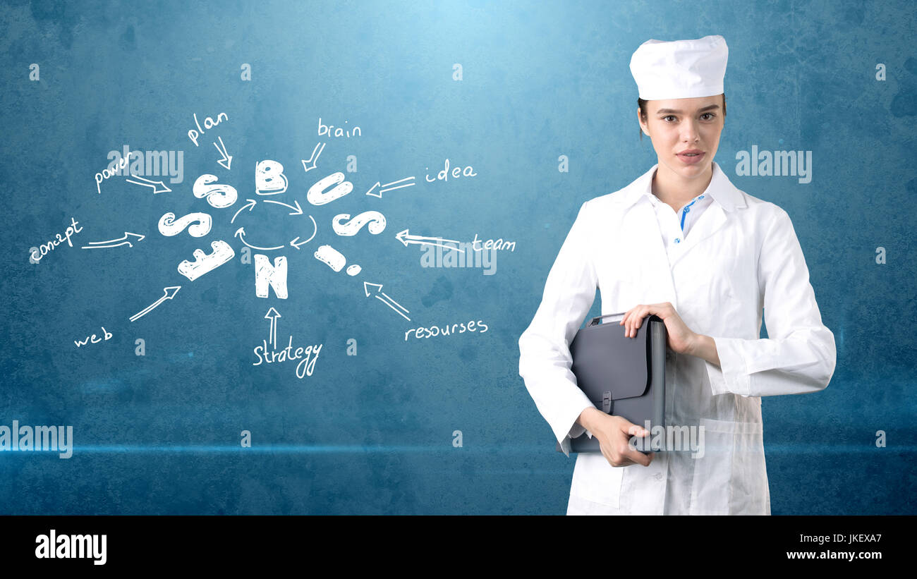 Beautiful medical woman doctor in uniform. Studio painted background ...