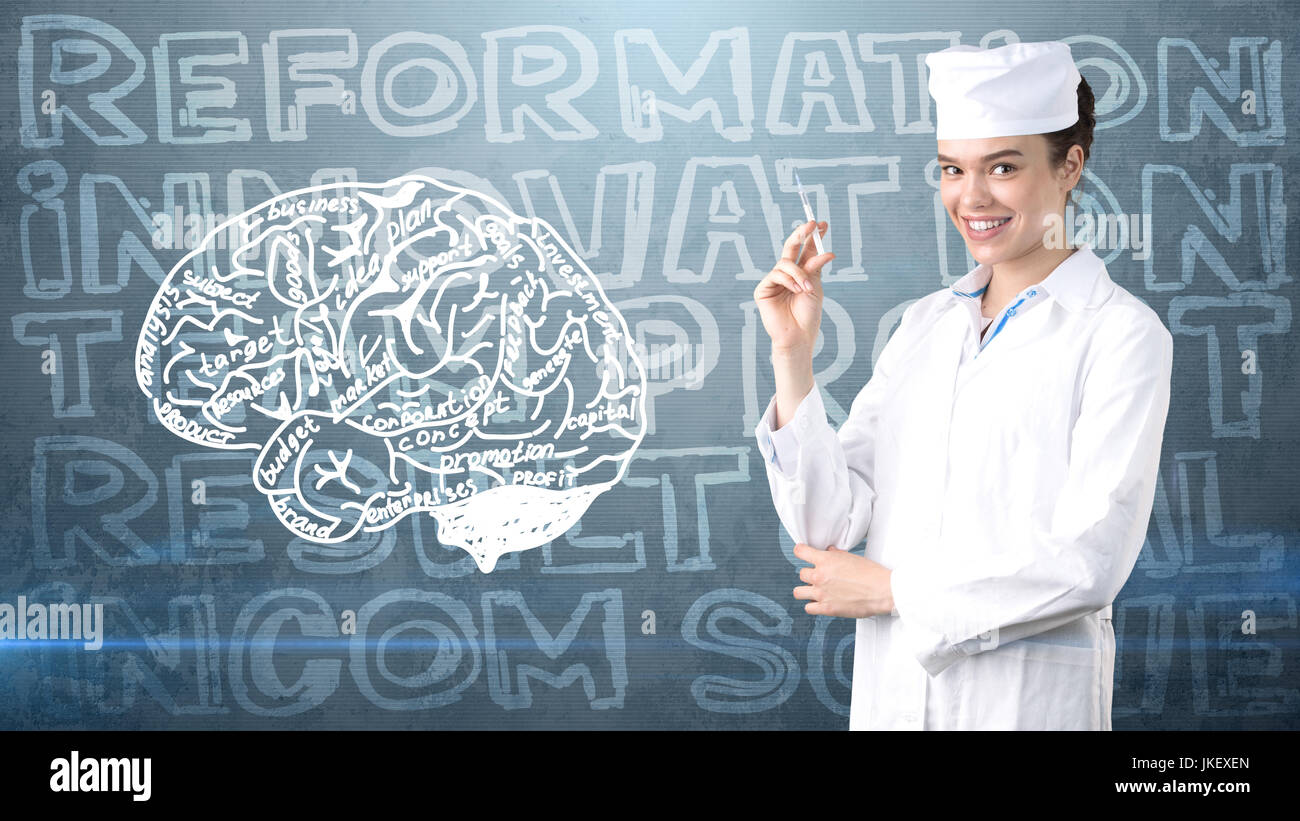 Beautiful medical woman doctor in uniform. Studio painted background ...