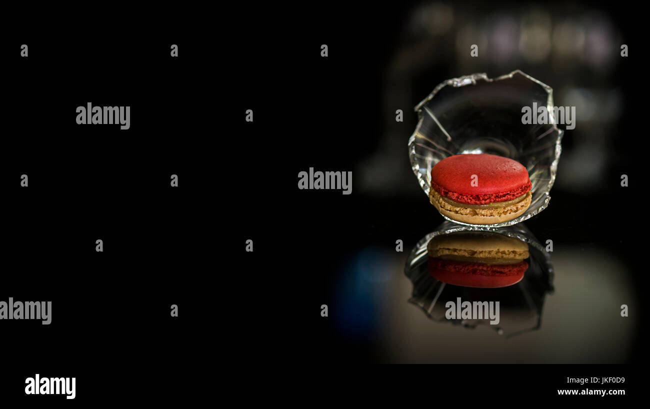 Sweet and colorful french macaroon (macaron) in broken glass with ...