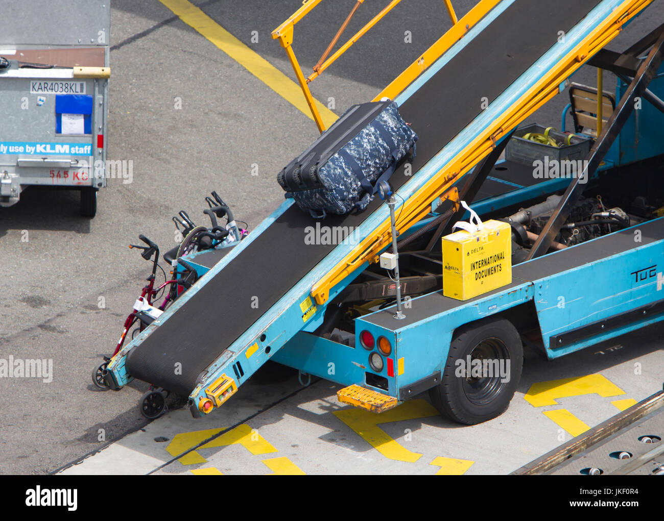 AMSTERDAM, NETHERLANDS - JUNE 29, 2017: Loading luggage in airplane at ...