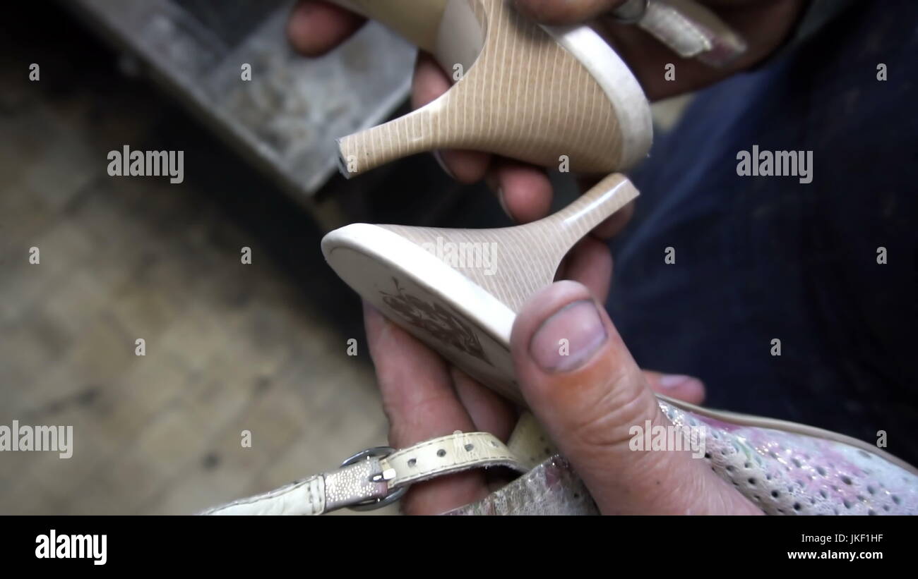 the shoemaker at work.The process of repairing shoes in workshop Stock ...