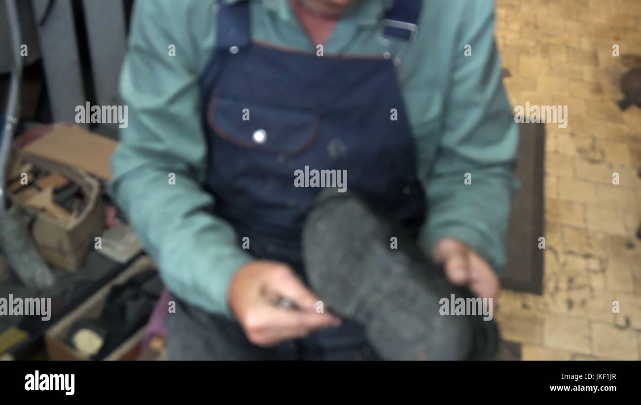 the shoemaker at work.The process of repairing shoes in workshop Stock ...
