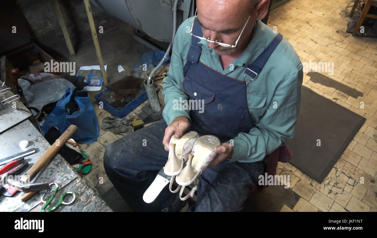 the shoemaker at work.The process of repairing shoes in workshop Stock ...