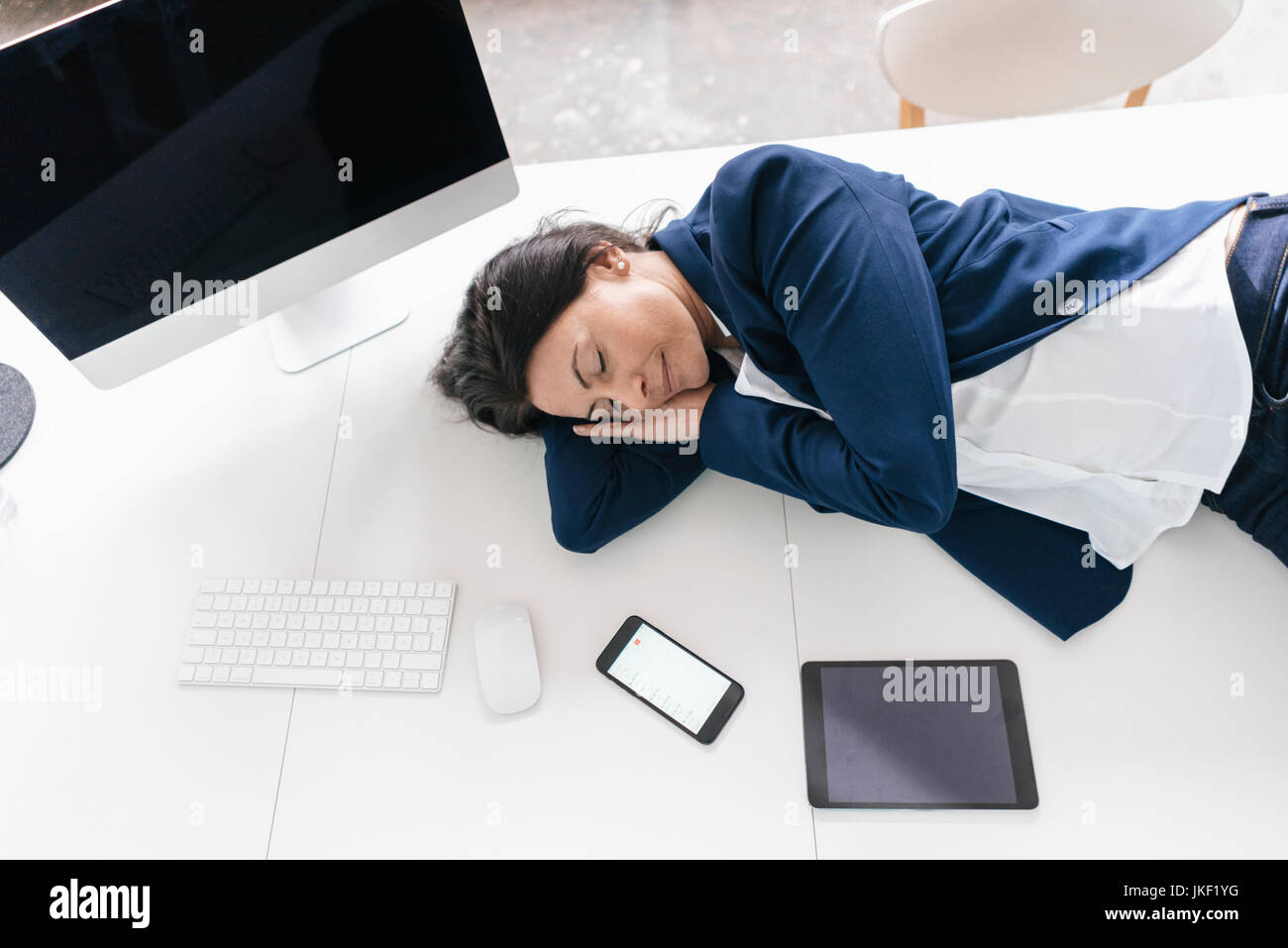 Businesswoman sleeping on desk in the office Stock Photo - Alamy