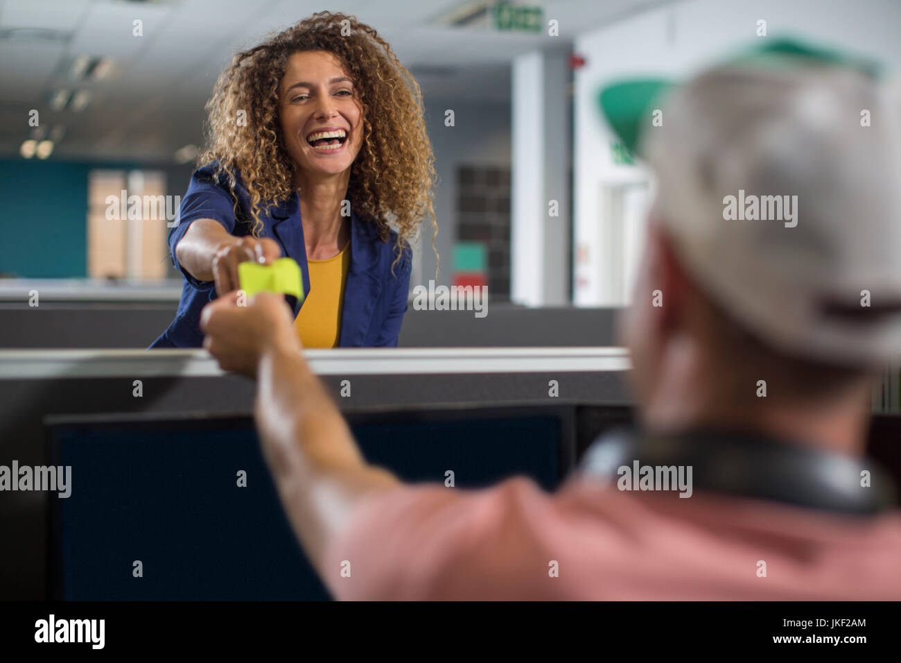 Colleagues in office exchanging notes Stock Photo - Alamy
