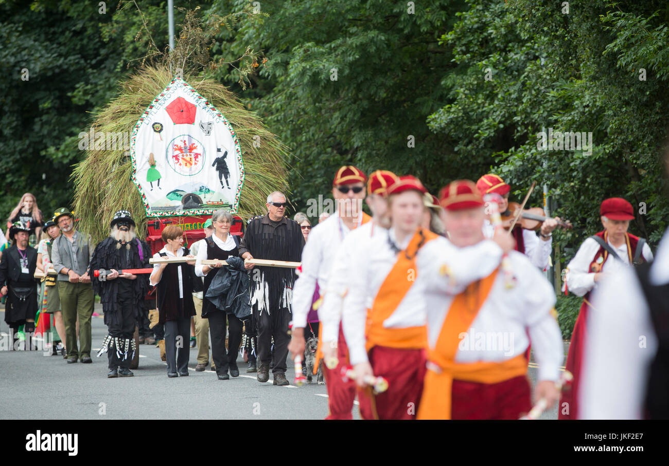 People take part in the Rush Cart procession during the Rushbearing ...