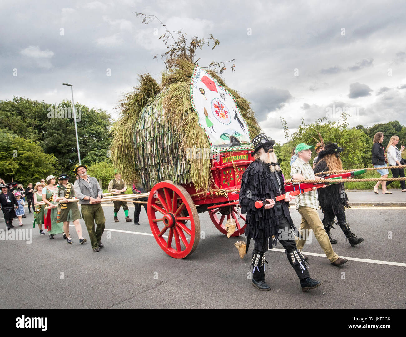 People take part in the Rush Cart procession during the Rushbearing ...