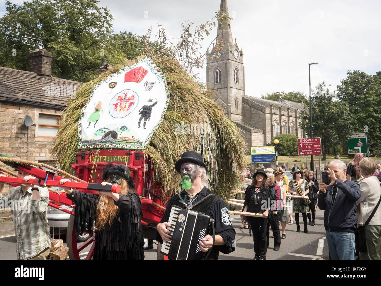 People take part in the Rush Cart procession during the Rushbearing ...