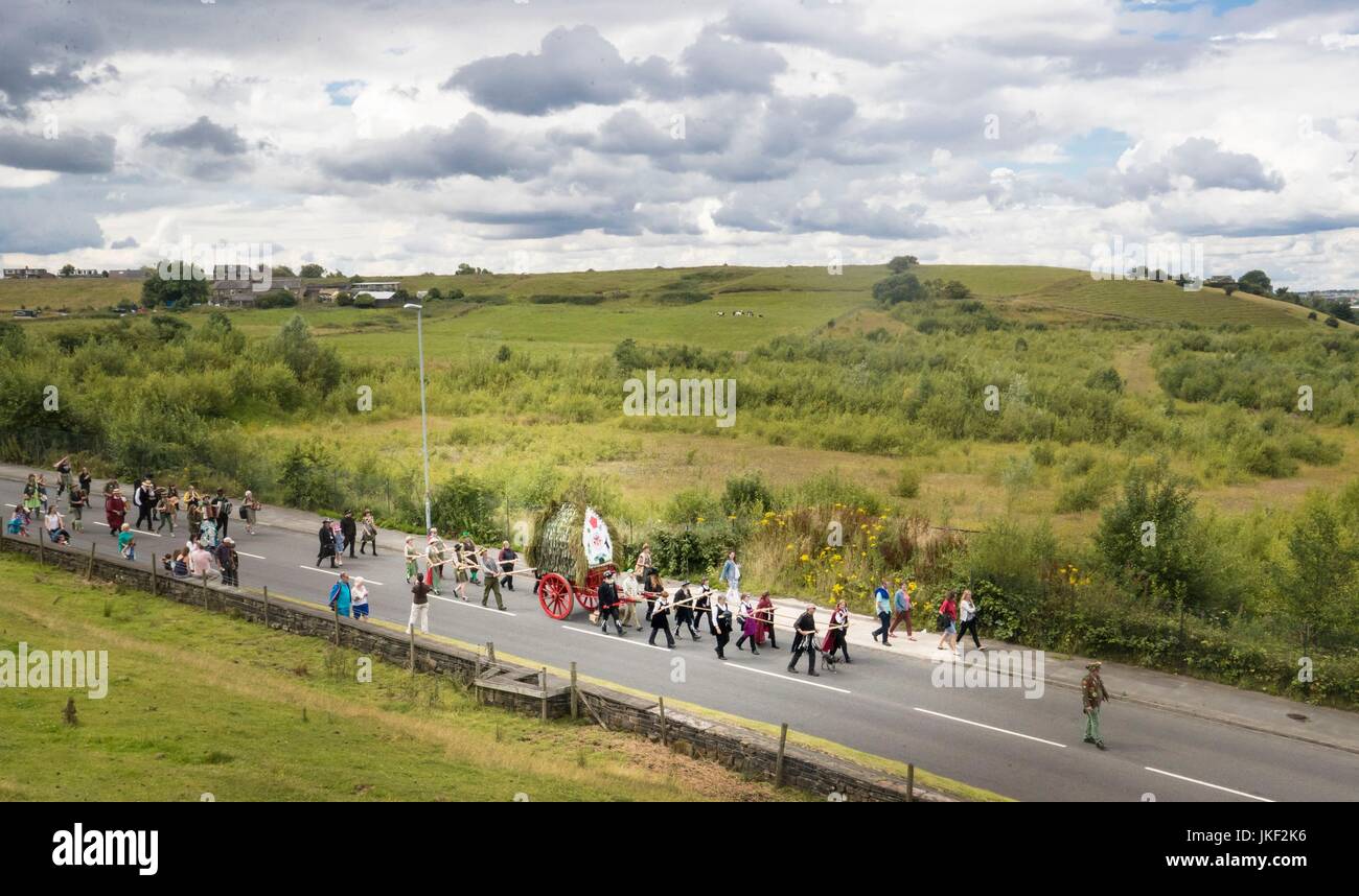 People take part in the Rush Cart procession during the Rushbearing ...