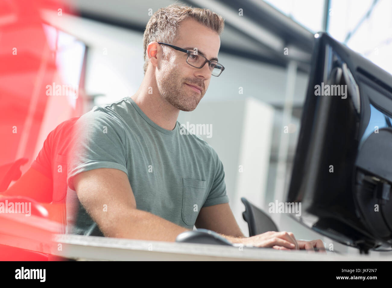 Employee working on his computer Stock Photo - Alamy