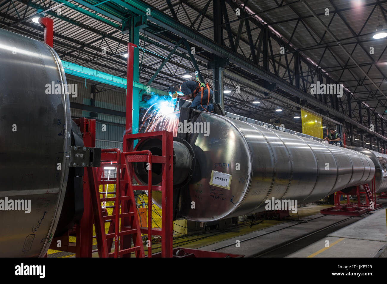 Man welding large steel tank in factory Stock Photo - Alamy