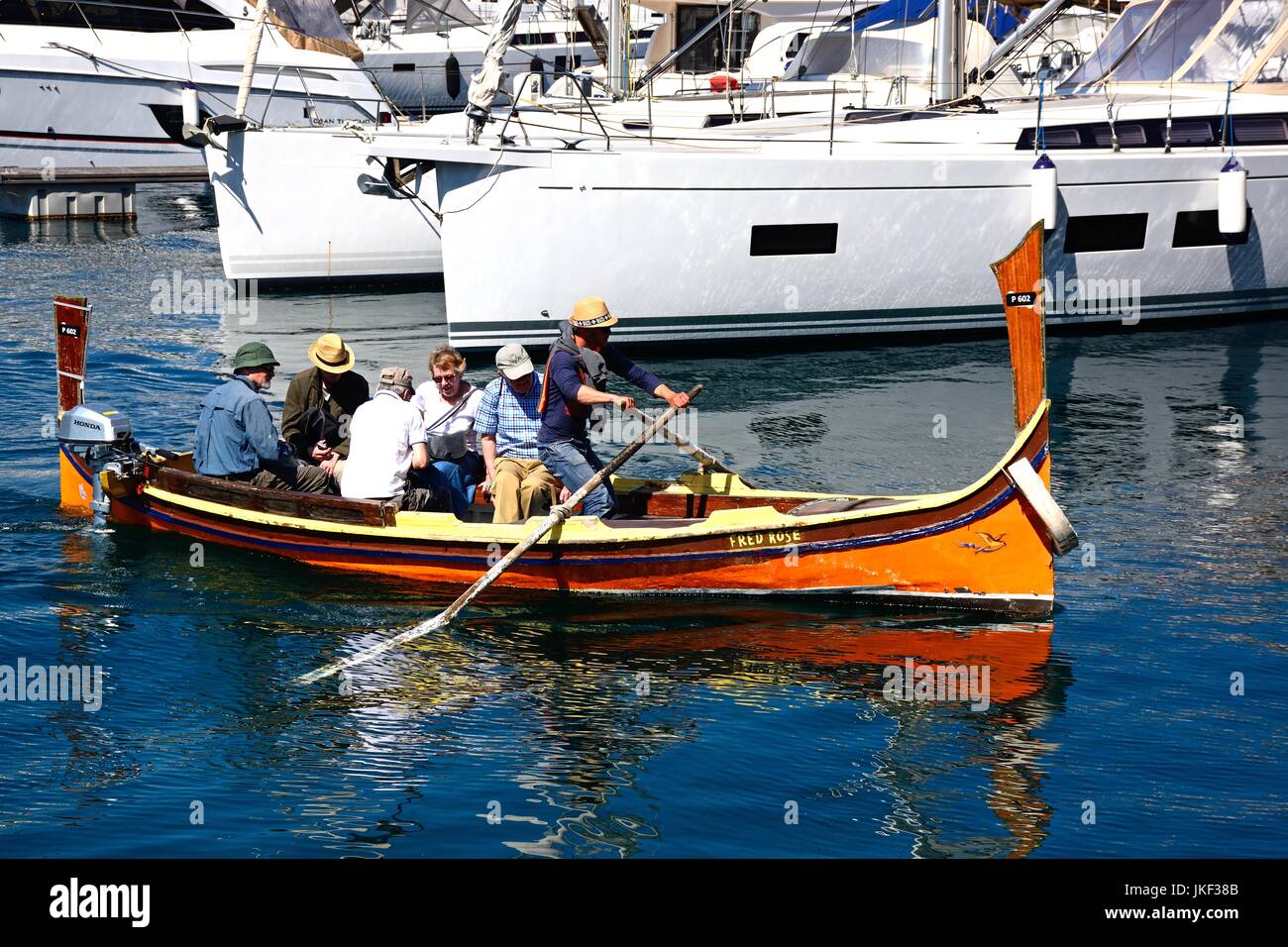 Passengers on board a traditional Maltese Dghajsa water taxi in the ...