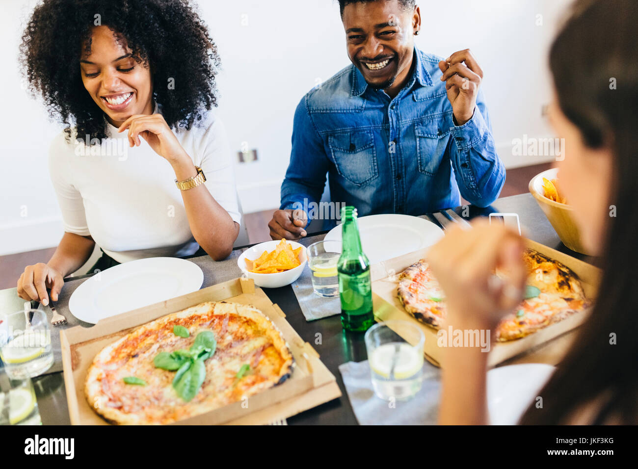 Group of friends having a pizza at home Stock Photo - Alamy