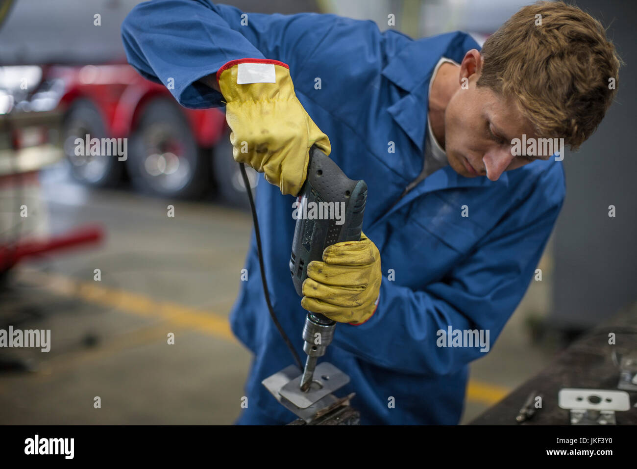Industrial worker drilling Stock Photo - Alamy